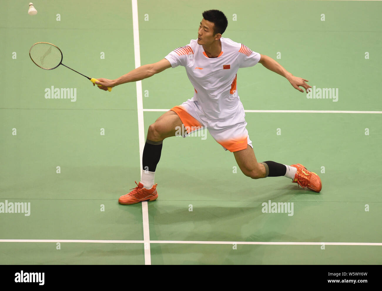 Chen Long of China returns a shot to Liew Daren of Malaysia in their ...