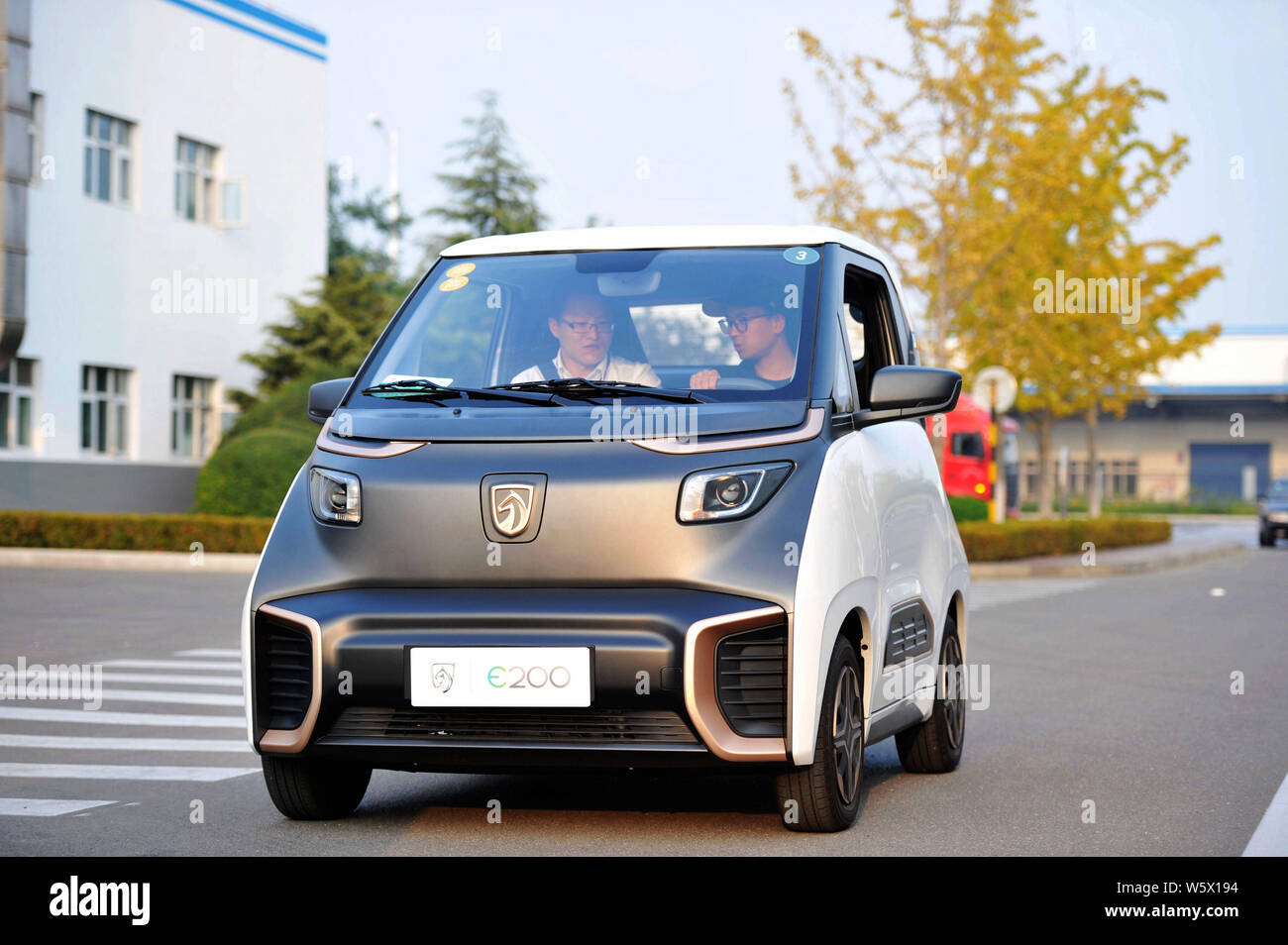 --FILE--Chinese customers try out a Baojun E200 electric vehicle at an ...