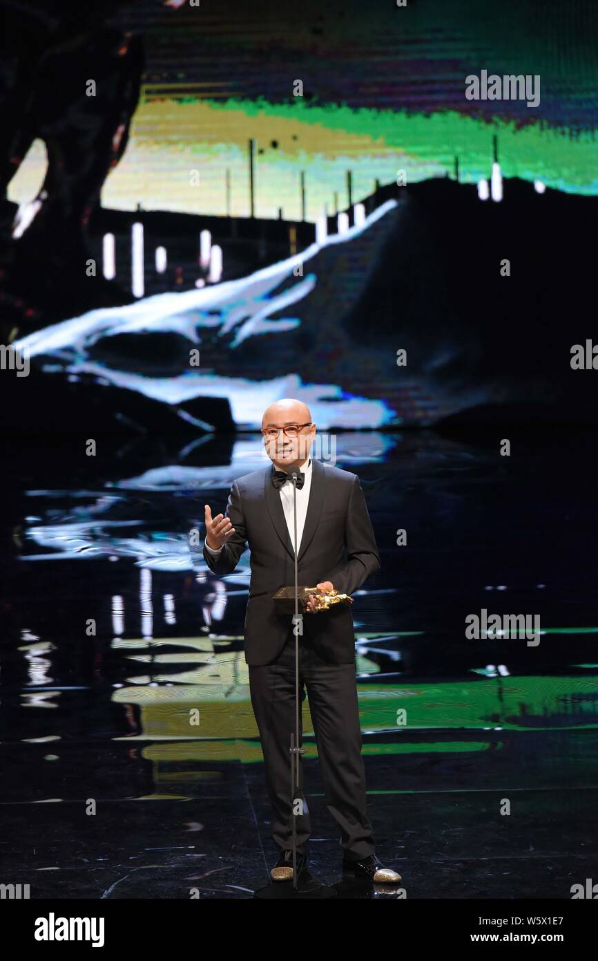 Chinese actor Xu Zheng speaks after being awarded with the trophy of ...