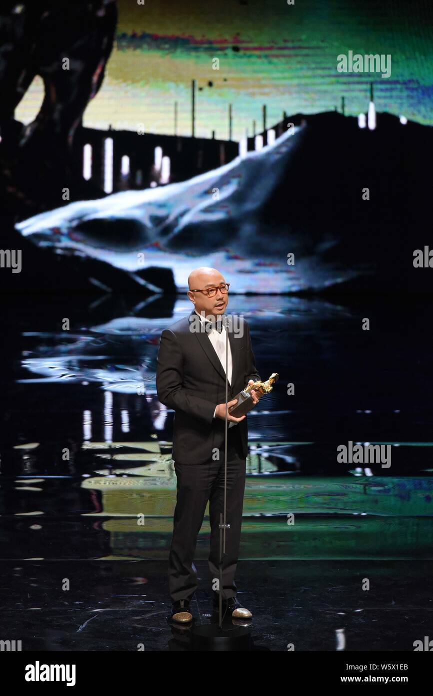 Chinese actor Xu Zheng speaks after being awarded with the trophy of ...
