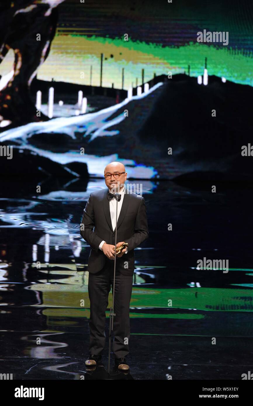 Chinese actor Xu Zheng speaks after being awarded with the trophy of ...