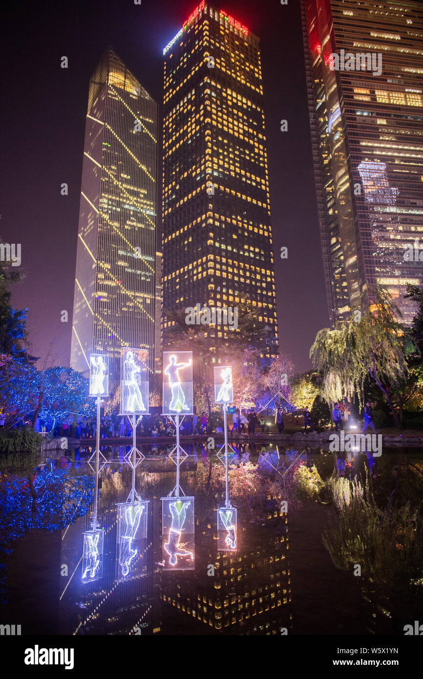 Tourists and visitors view colored lights during the seventh Guangzhou International Light ...