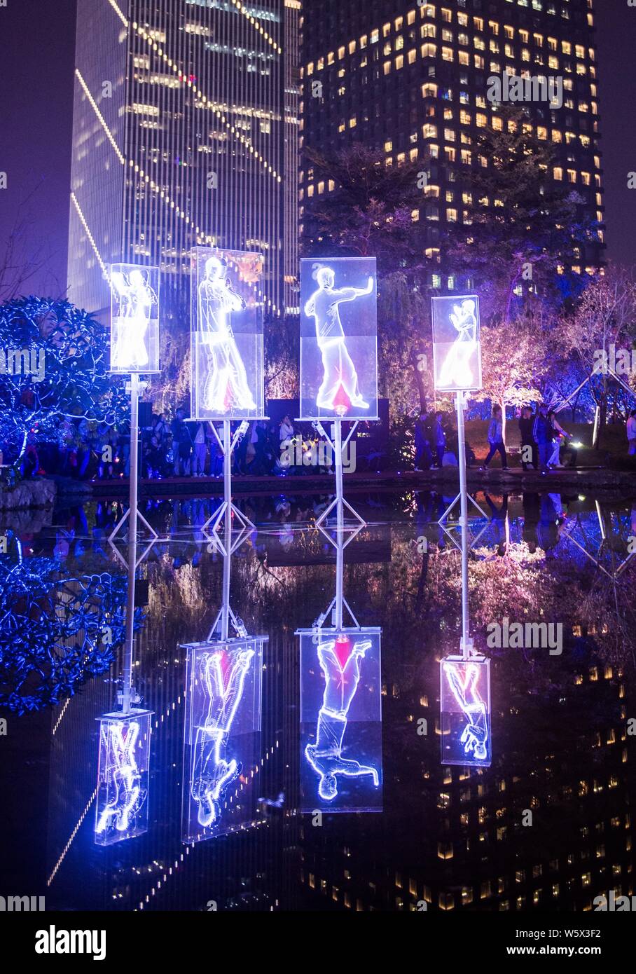 Tourists and visitors view colored lights during the seventh Guangzhou International Light ...
