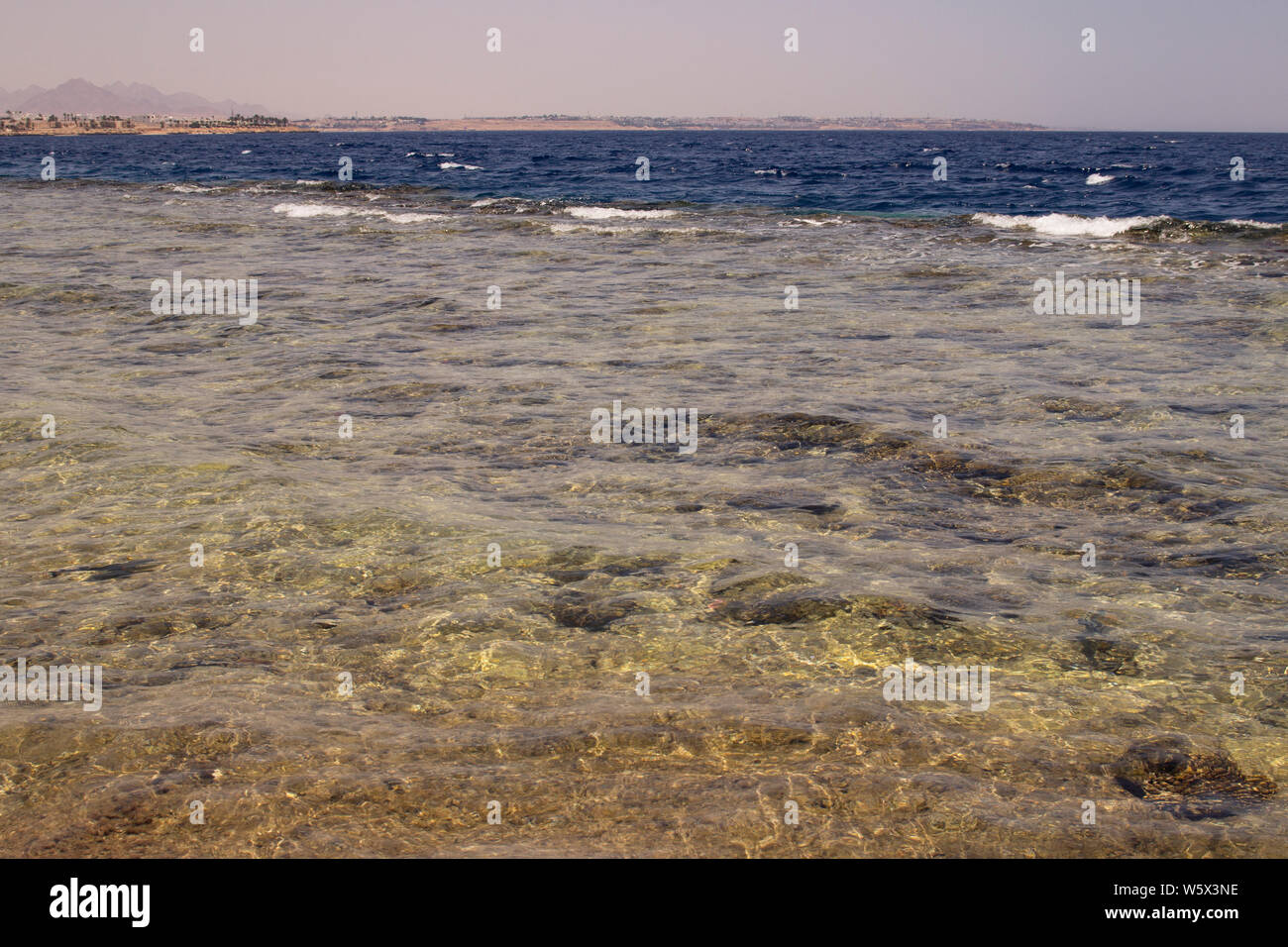 Summer background of hot sand with sea or ocean wave bubbles with copy ...