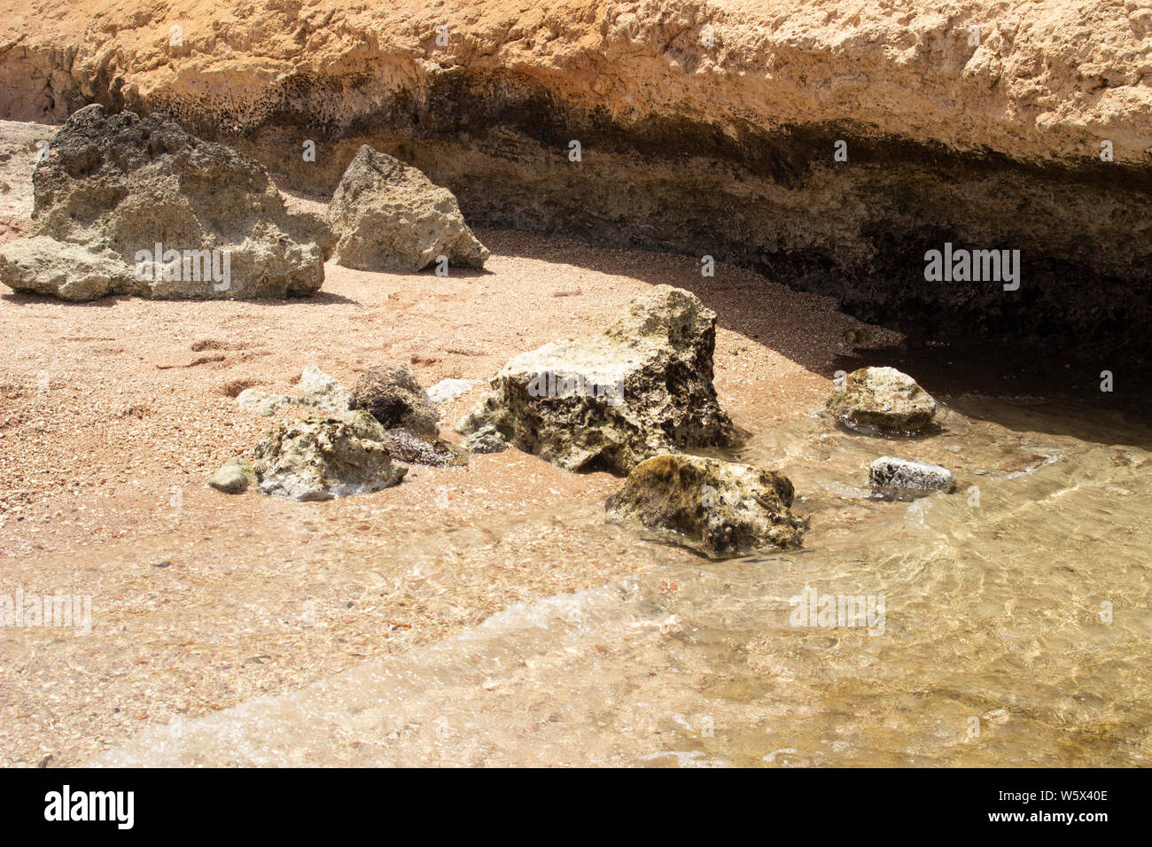 Summer background of hot sand with sea or ocean wave bubbles with copy ...