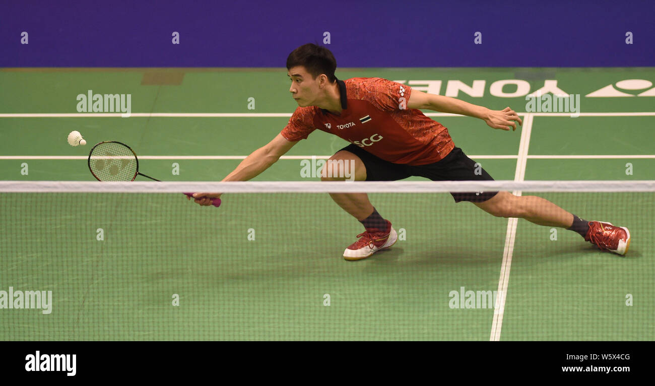 Kantaphon Wangcharoen of Thailand returns a shot to Angus Ng Ka Long of ...