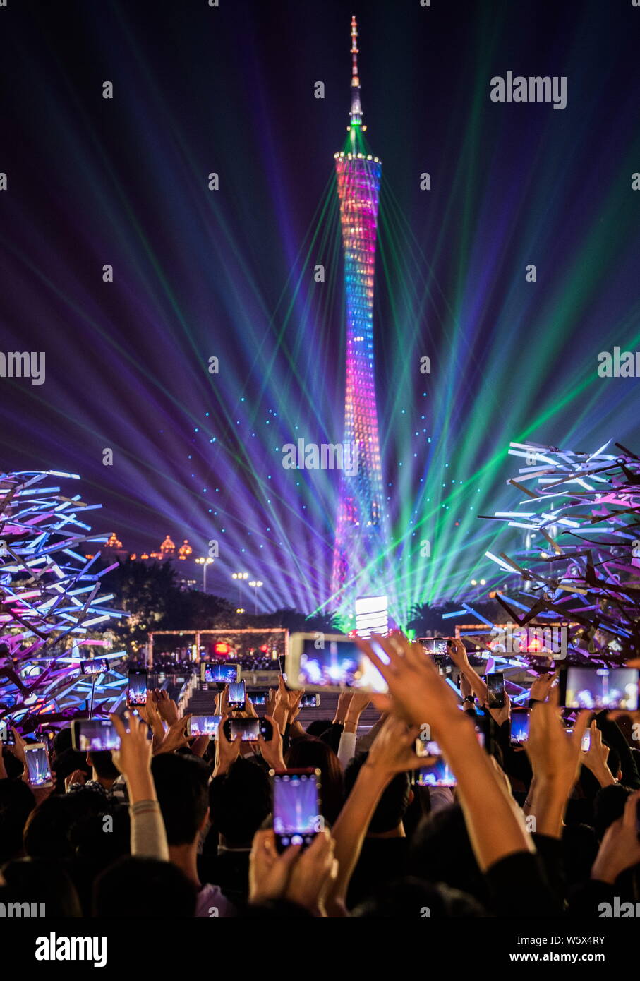 Tourists and visitors view colored lights during the seventh Guangzhou International Light ...