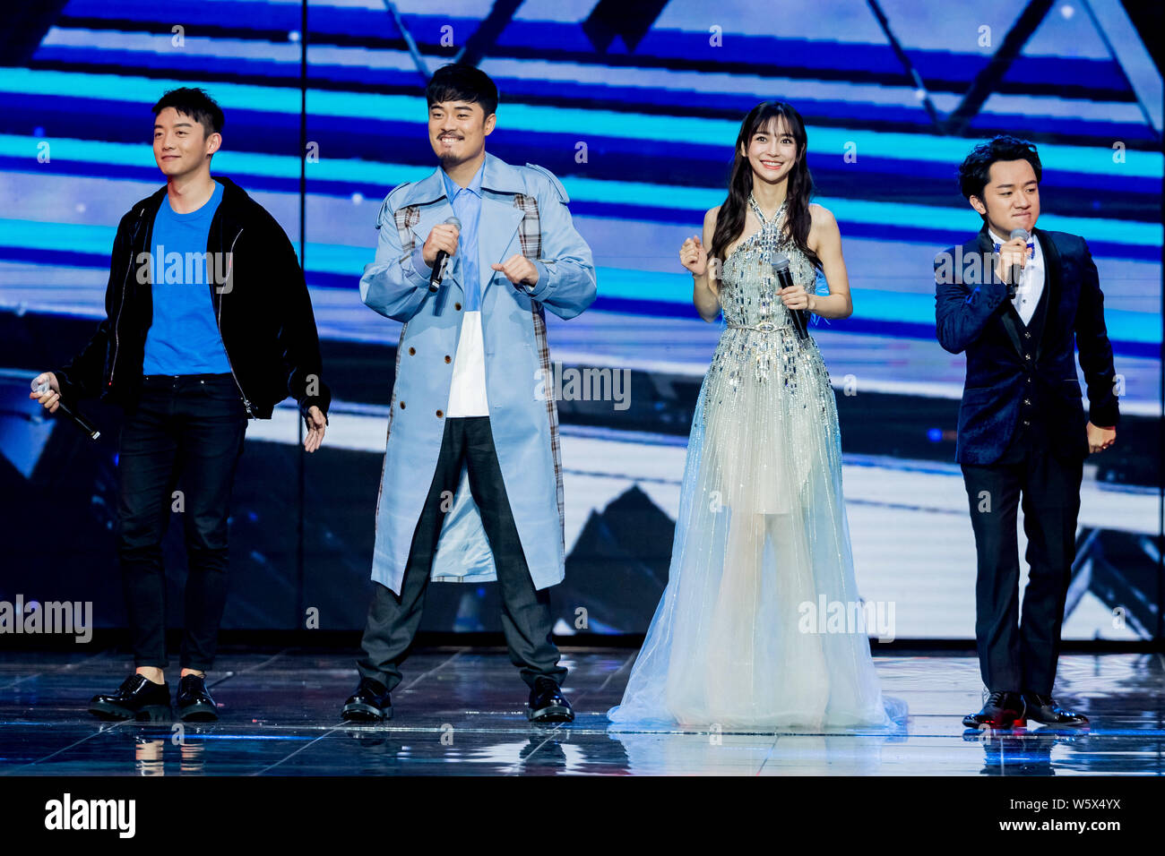 Hong Kong actress Angelababy, second right, performs during the gala of the Tmall 11.11 Global ...