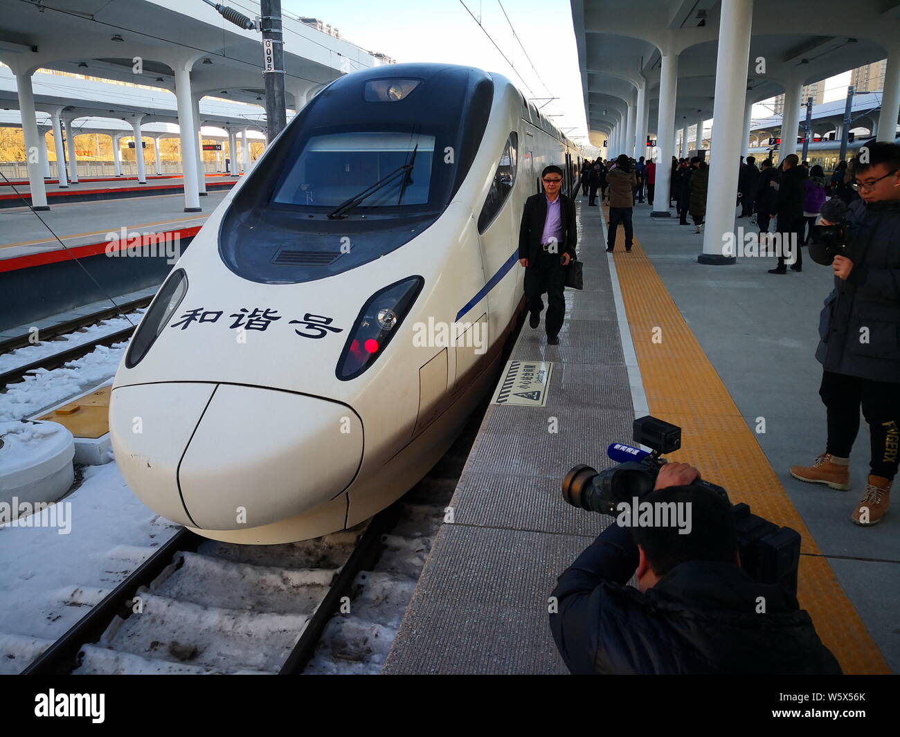 Passengers board a high-speed bullet train to Mudanjiang during a trial ...