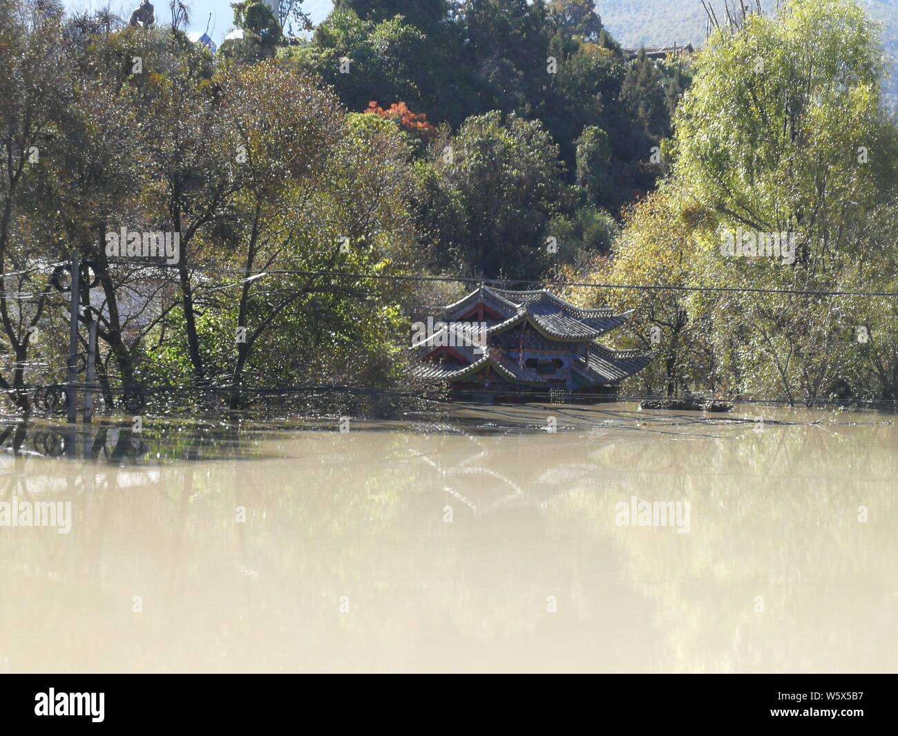 Residential buildings are submerged by floodwater after the arrival of ...