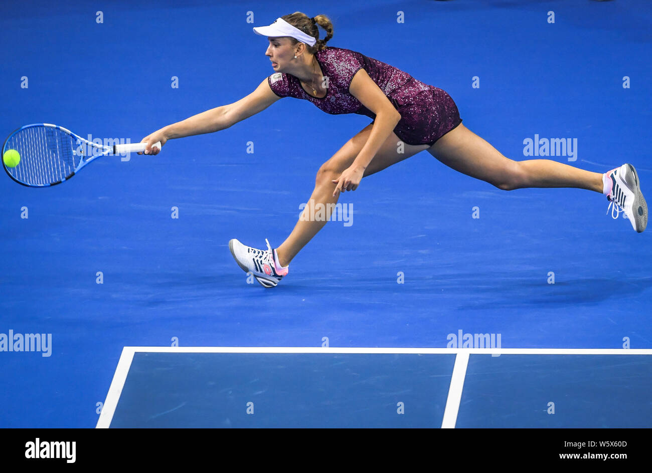 Elise Mertens of Belgium returns a shot to Julia Gorges of Germany in ...