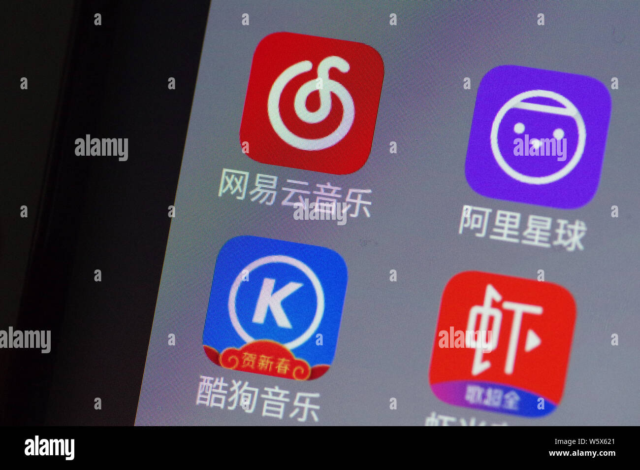 --FILE--A Chinese mobile phone user looks at the icon of the mobile app ...