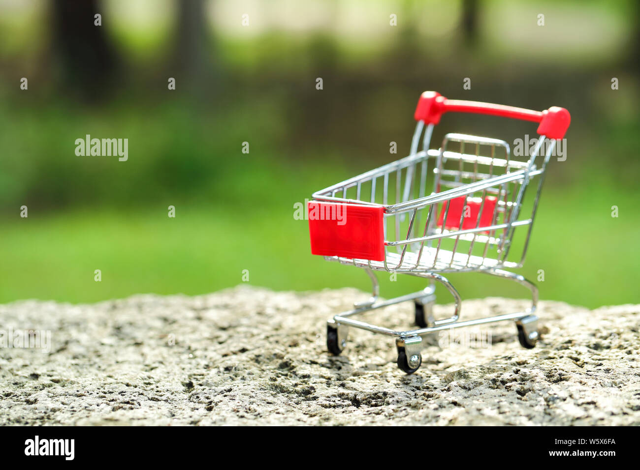 trolley with green background idea for shopping Stock Photo - Alamy