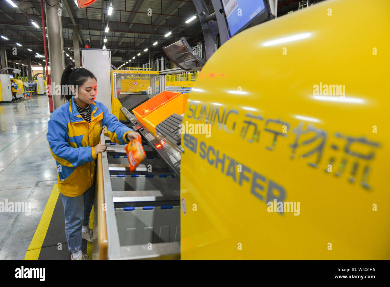 Chinese workers labor at the largest smart logistics base in Asia ...