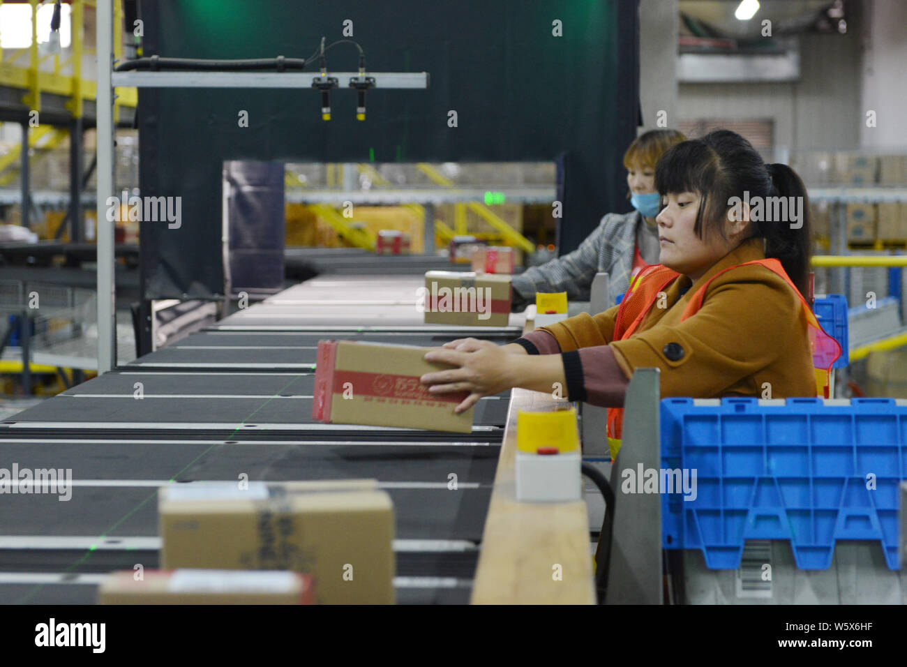 Chinese workers labor at the largest smart logistics base in Asia ...