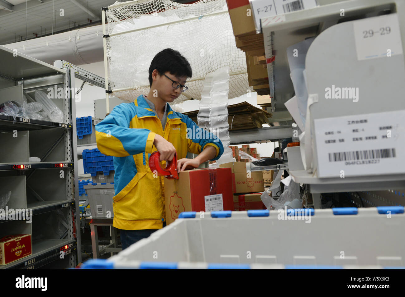Chinese workers labor at the largest smart logistics base in Asia ...