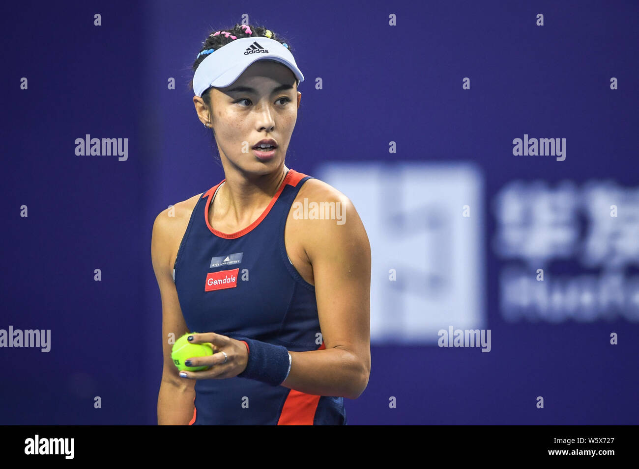 Wang Qiang of China serves against Madison Keys of the United States ...