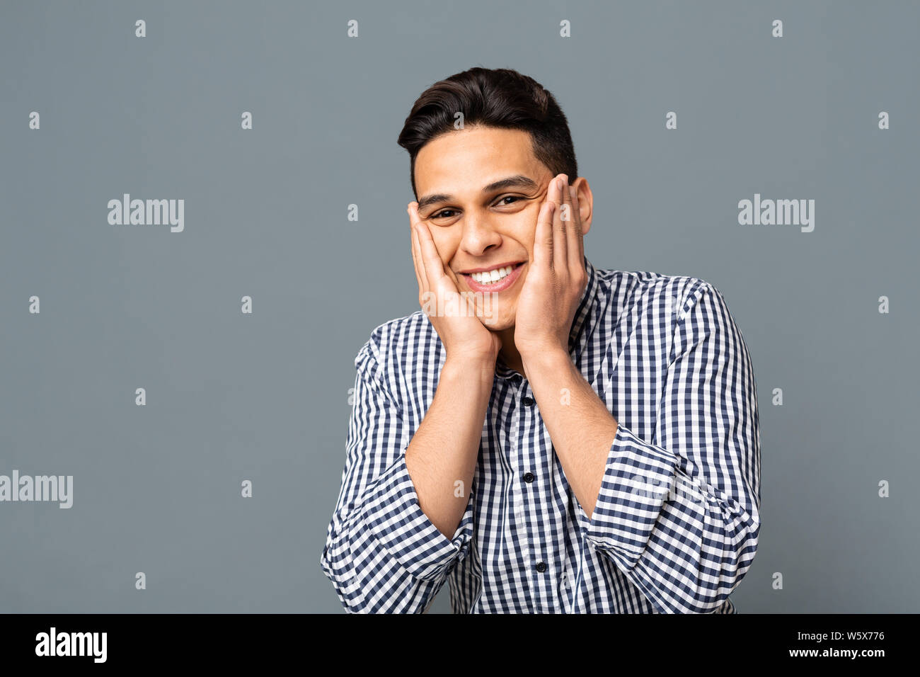 Happy Surprised Man Holding Face In Palms Over Gray Background Stock ...