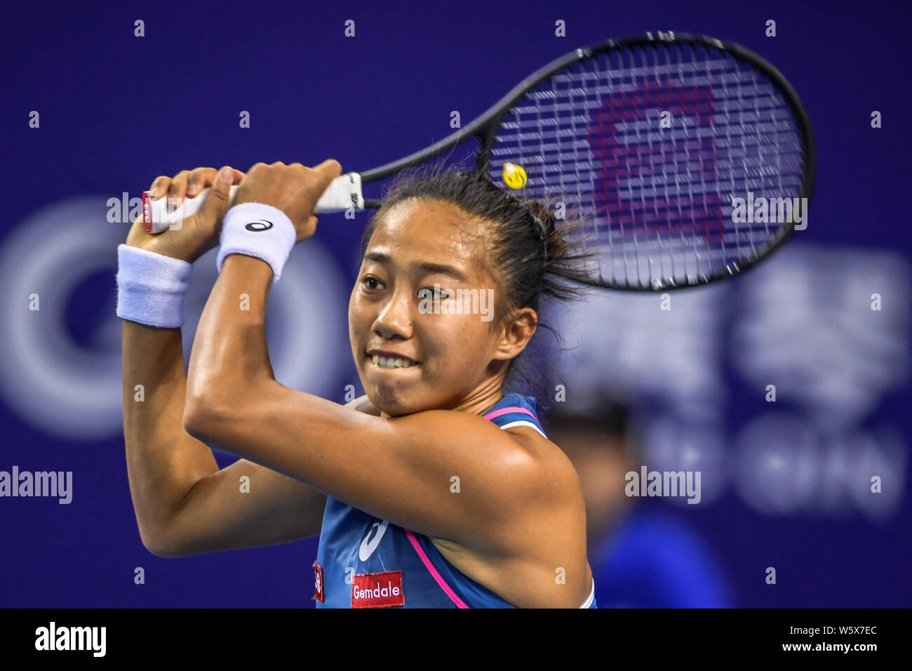 Zhang Shuai of China returns a shot to Anastasija Sevastova of Latvia ...