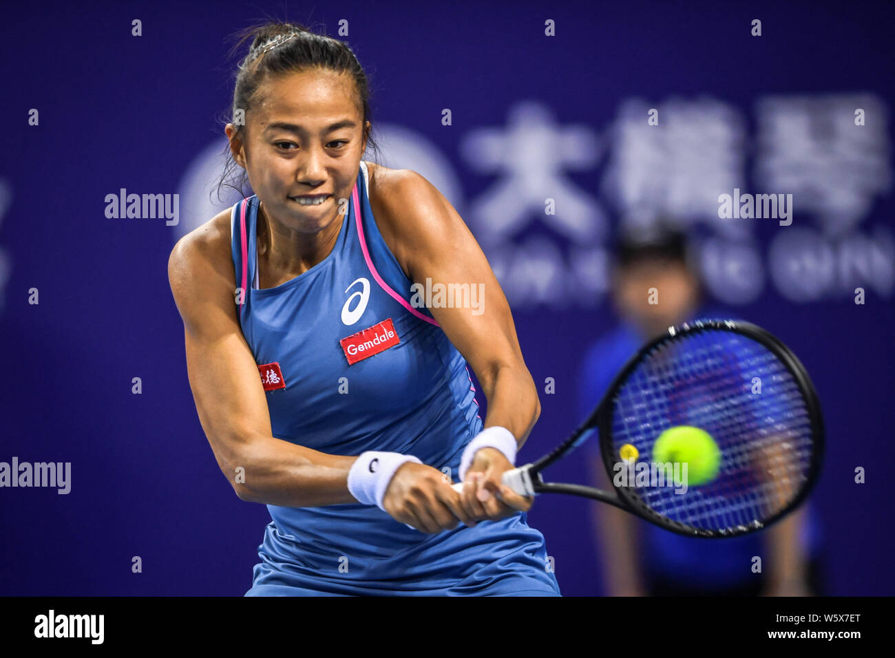 Zhang Shuai of China returns a shot to Anastasija Sevastova of Latvia ...