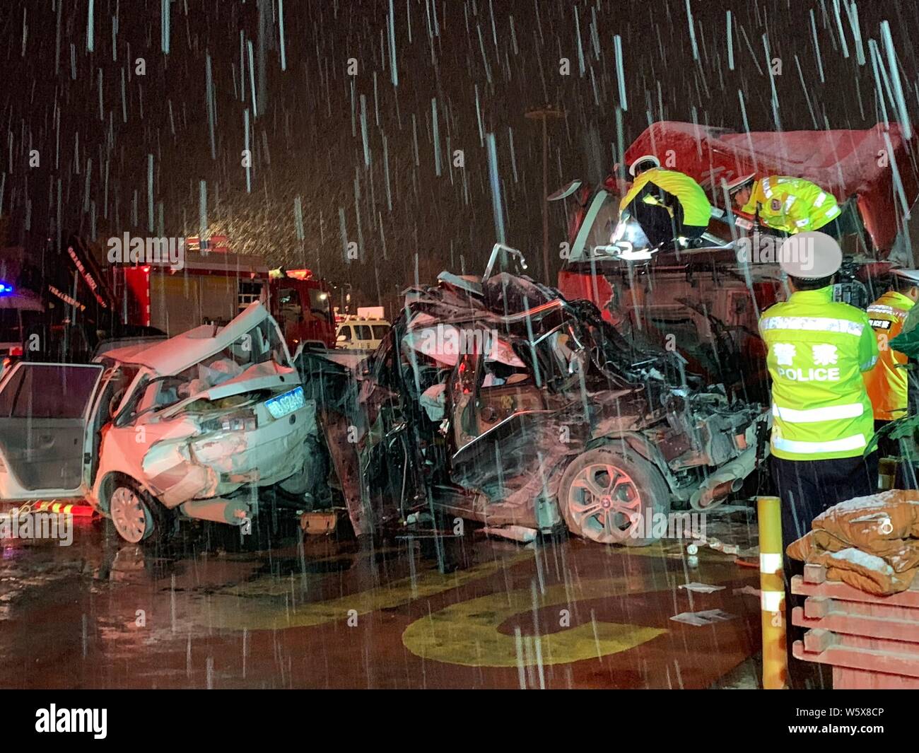 Chinese police officers investigate the accident site after a tower ...