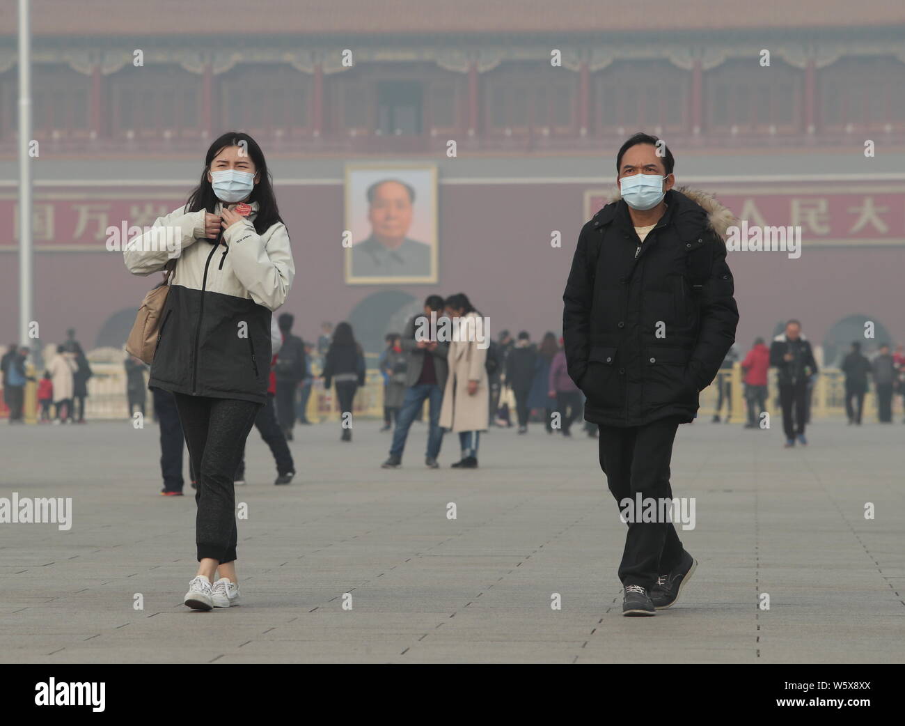 Chinese tourists wearing face masks against air pollution visit the ...