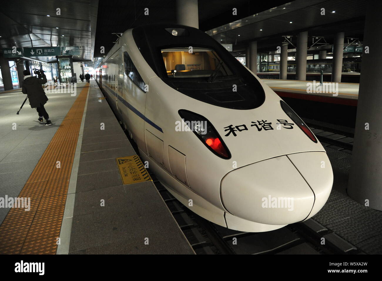 Passengers board a high-speed bullet train to Mudanjiang during a trial ...
