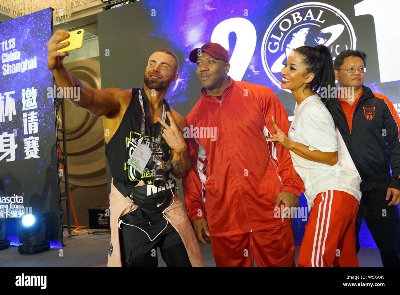 Jamaican-American IFBB professional bodybuilder Shawn Rhoden, center ...