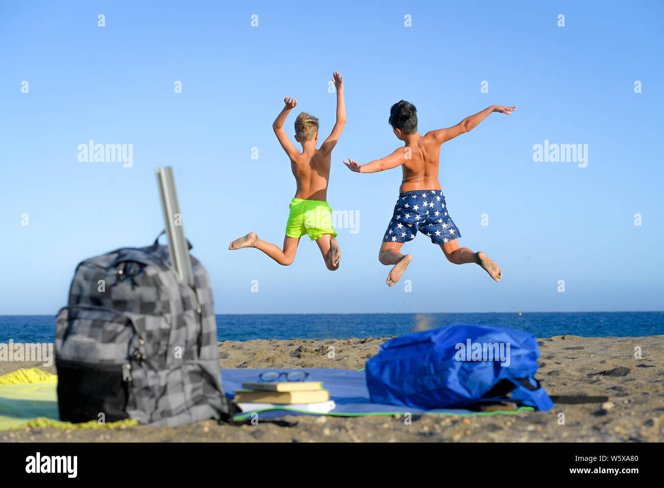 Two Boys Jumping Into The Sea High Resolution Stock Photography and ...