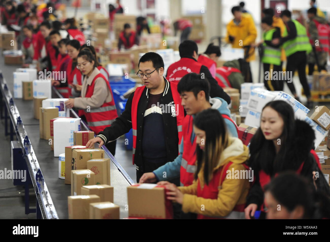 Chinese workers sort out parcels, most of which are from Singles' Day ...