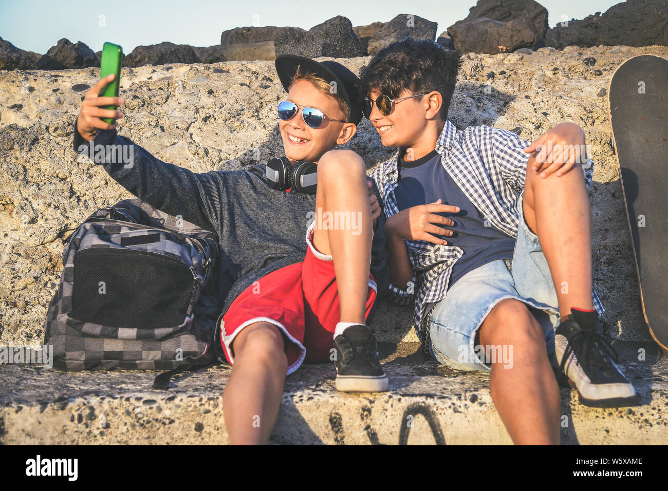 Caucasian smiling friends taking selfie with smartphone for social ...
