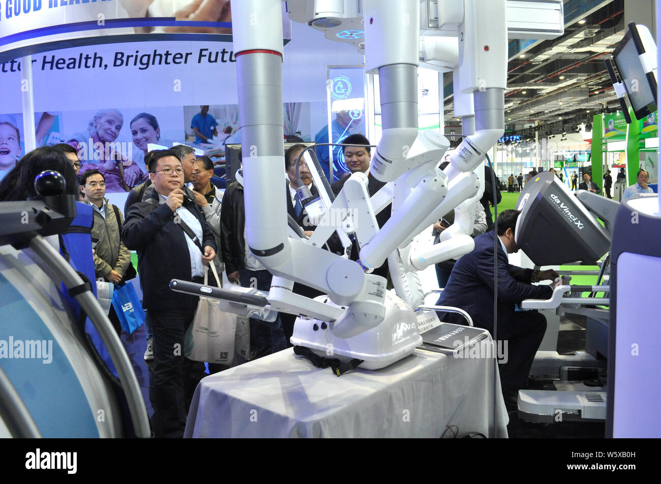 The da Vinci robotic-assisted surgical systems are on display during ...