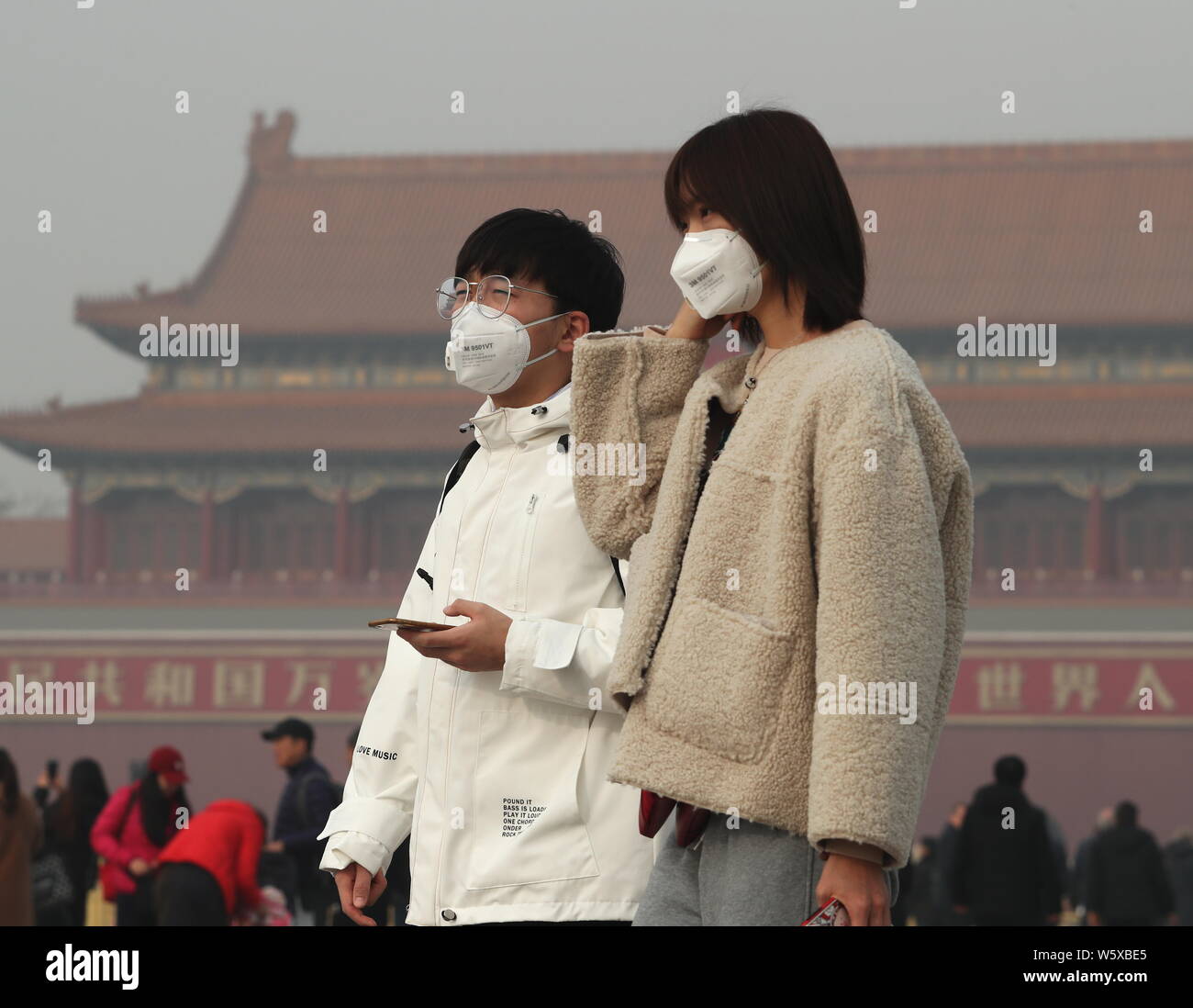 Chinese tourists wearing face masks against air pollution visit the ...