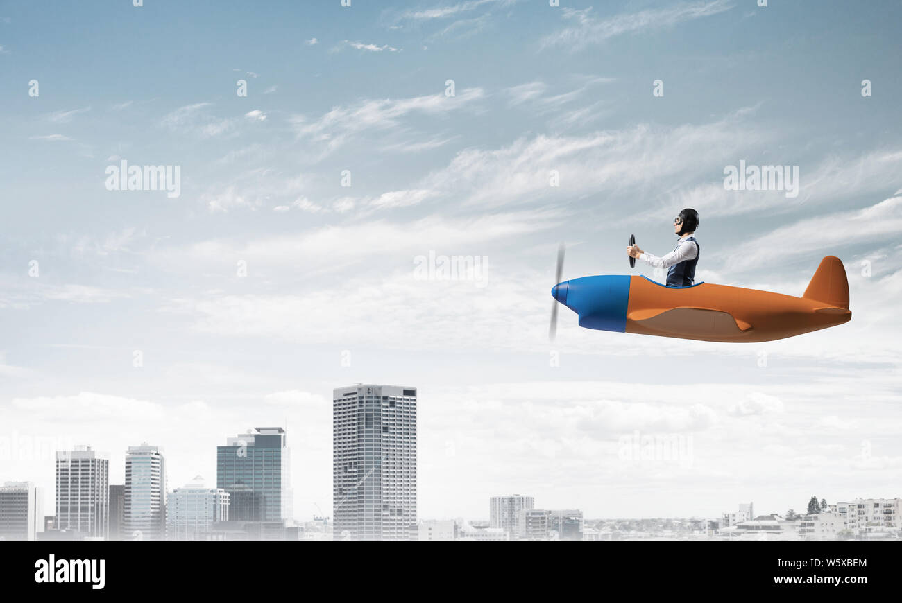 Pilot sitting in cabin of small airplane and holding steering wheel ...