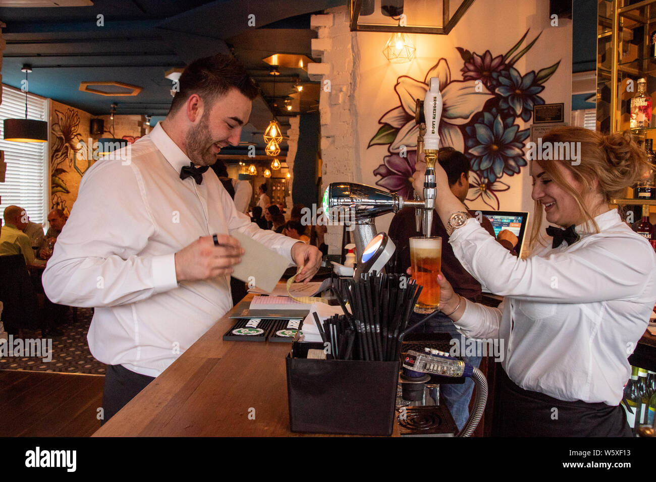 Doncaster, UK - May 11 2019: Barman and waitresses share a joke at the ...