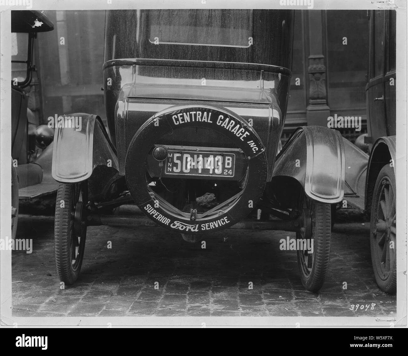 Rear view of cars; Scope and content: License plates are from Minn ...