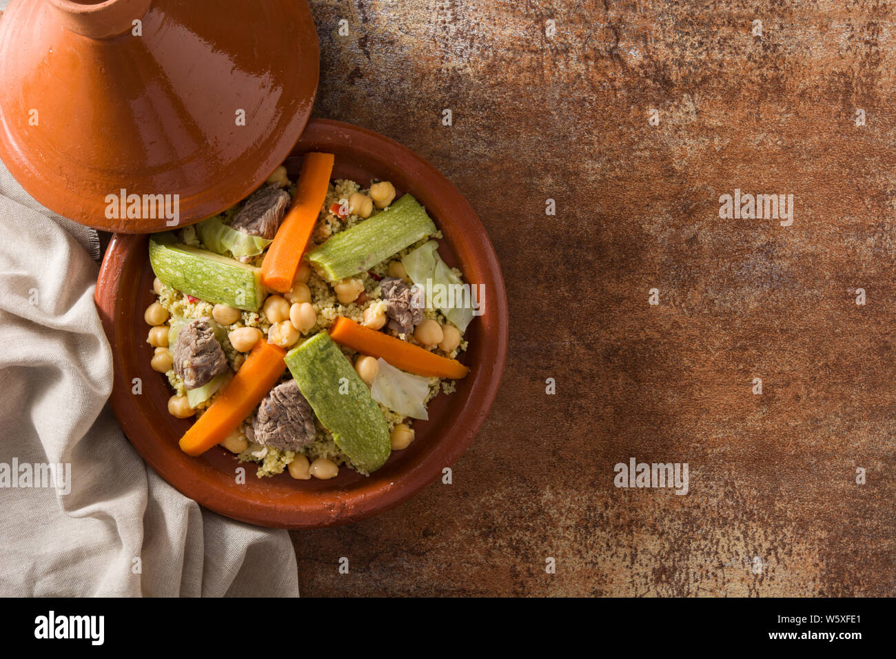 Traditional tajine with vegetables, chickpeas, meat and couscous on ...
