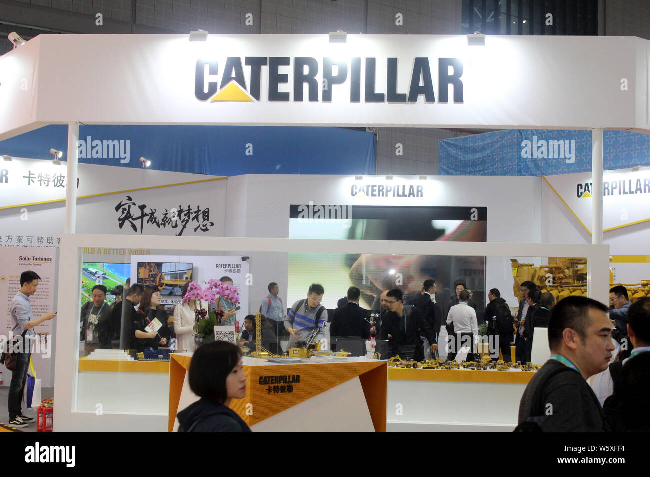 --FILE--People visit the stand of Caterpillar during the first China ...