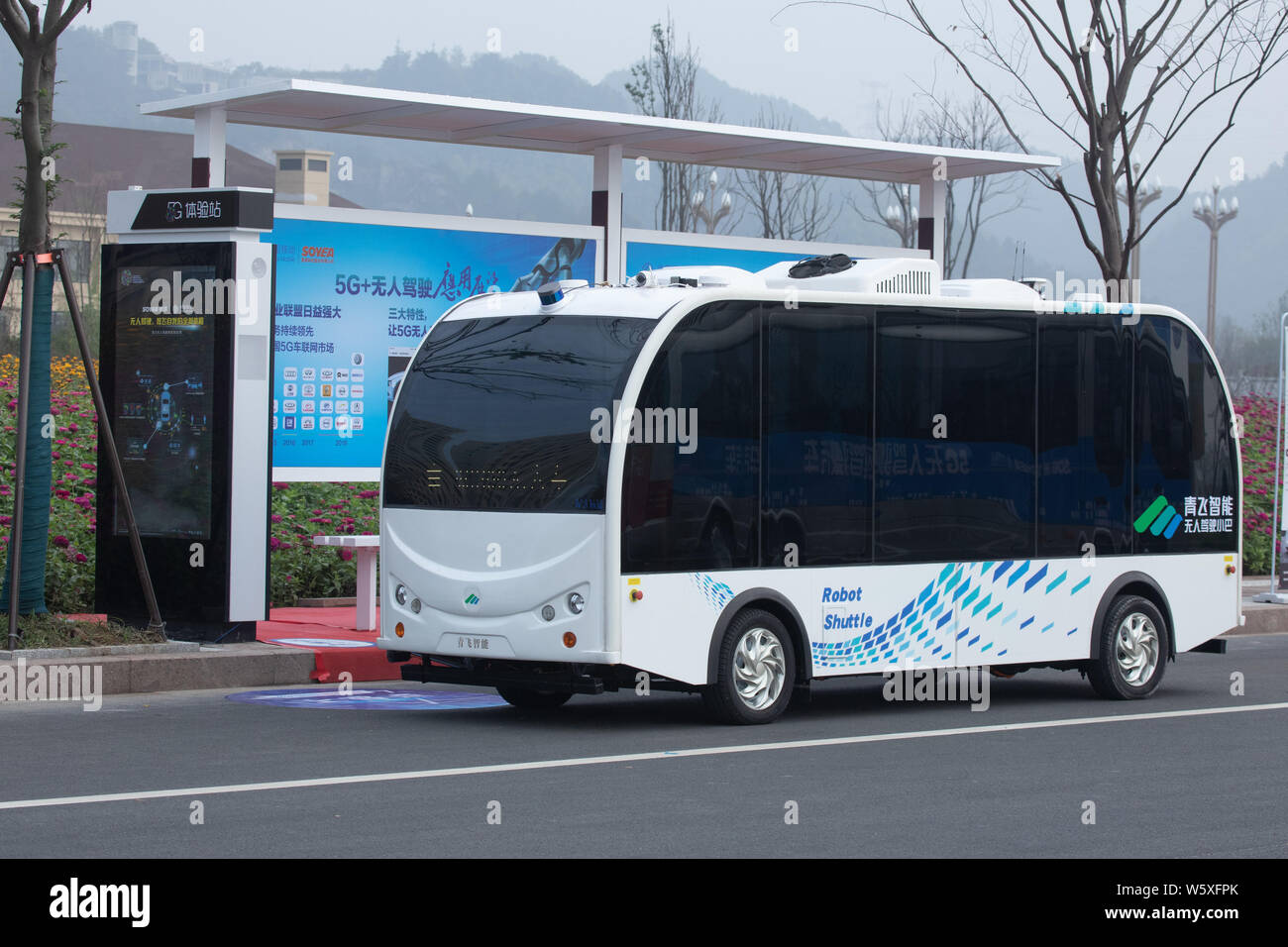 Chinese volunteers take an UISEE self-driving vehicle at the ...