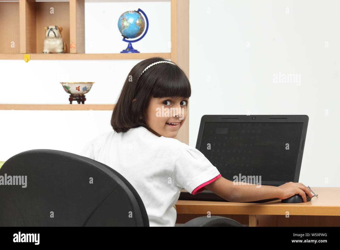 Indian girl studying on laptop desk hi-res stock photography and images ...