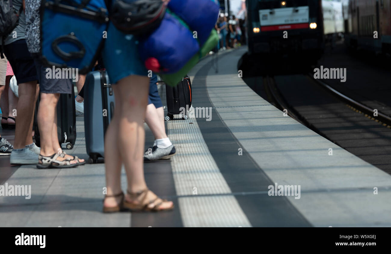 30 July 2019, Germany (German), Berlin: Passengers are standing at a ...
