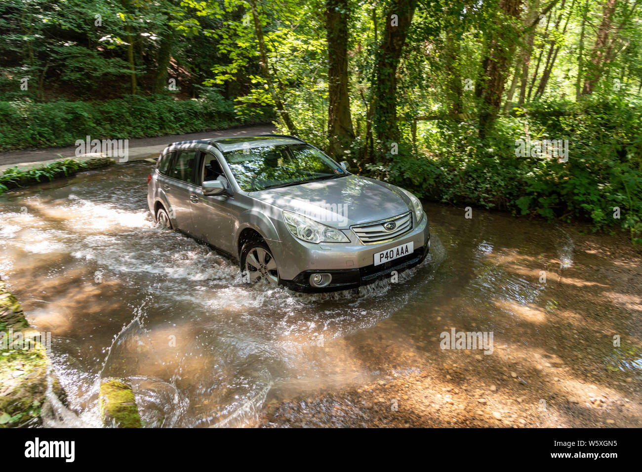Cheltenham, England, UK. A 4x4 car crossing a ford in the River ...