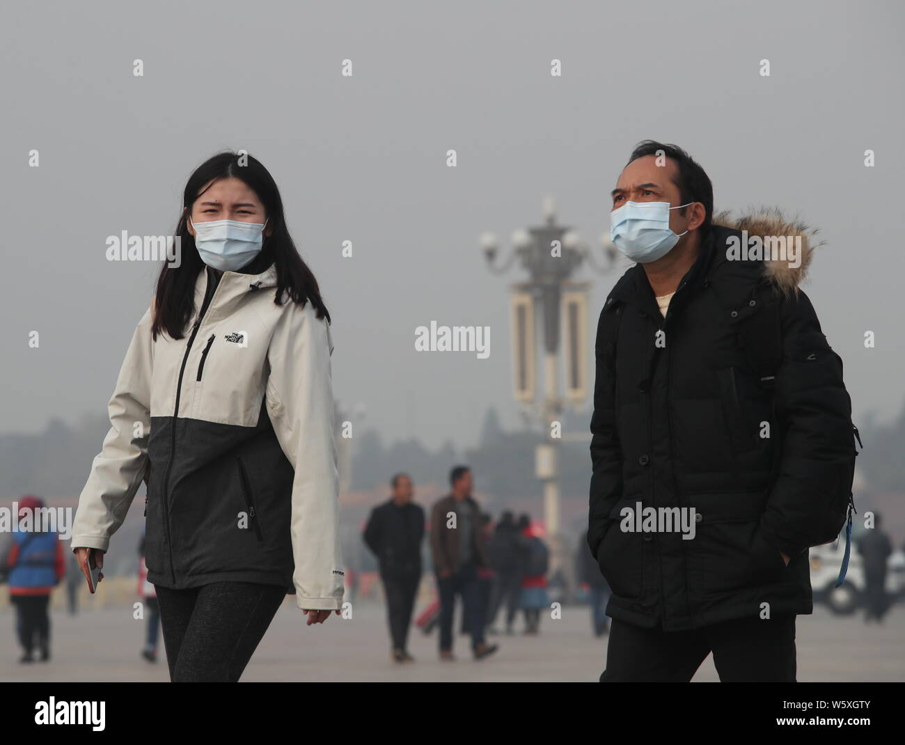 Chinese tourists wearing face masks against air pollution visit the ...
