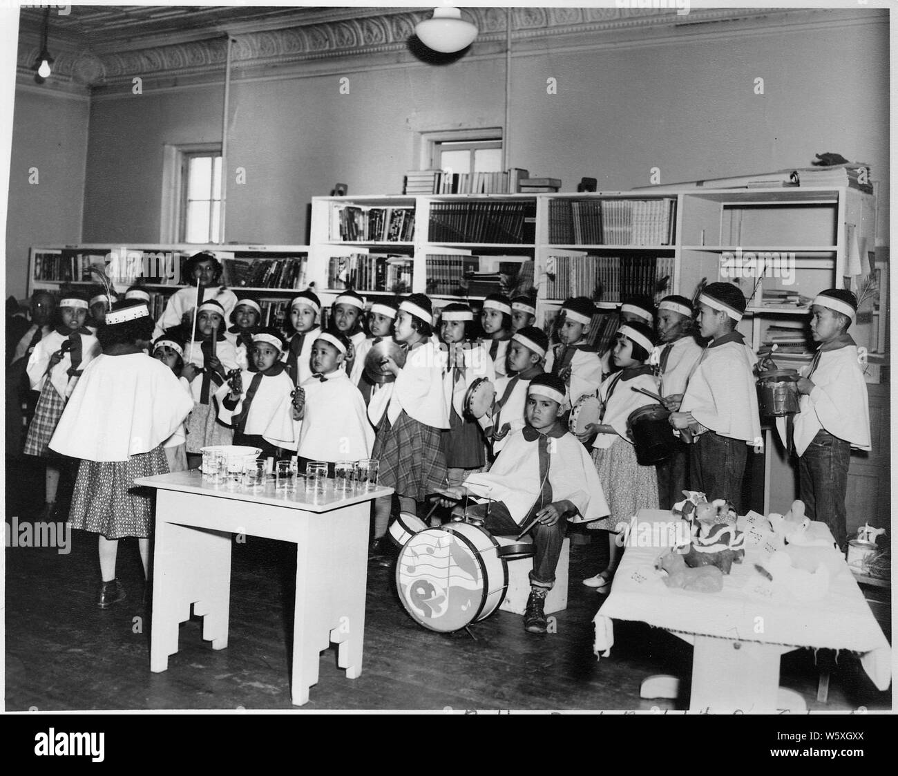 [Rhythm band student performing in day school library.] Stock Photo - Alamy