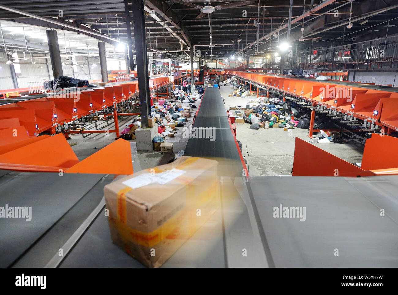 Chinese workers sort out parcels, most of which are from Singles' Day online shopping, at a ...