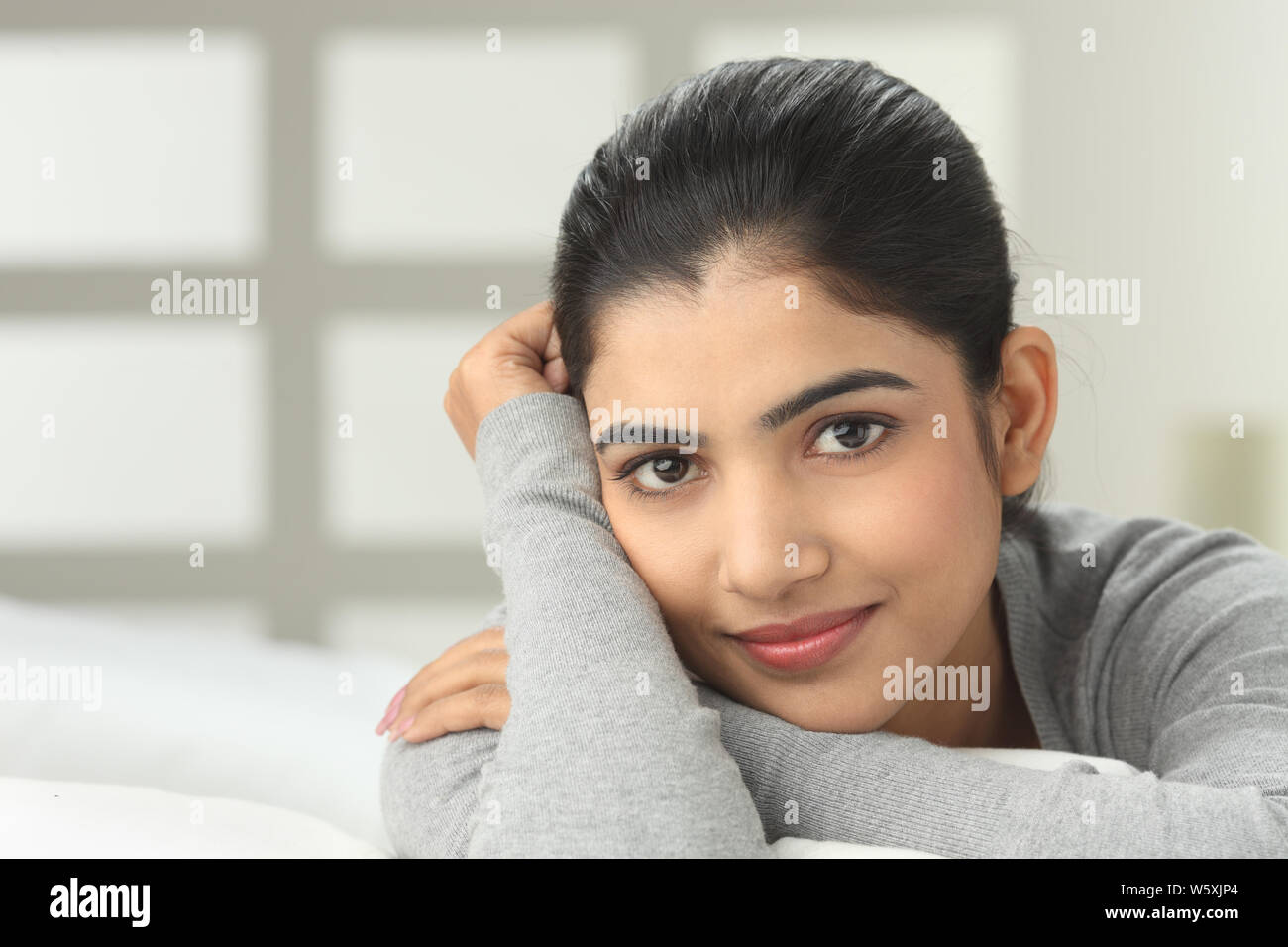 Portrait of a woman lying on bed Stock Photo - Alamy