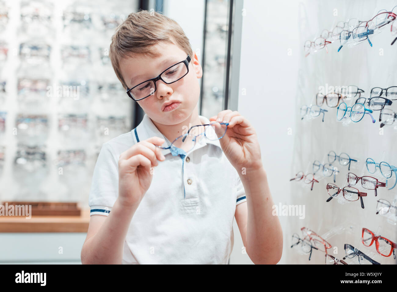 Boy trying glasses hi-res stock photography and images - Alamy