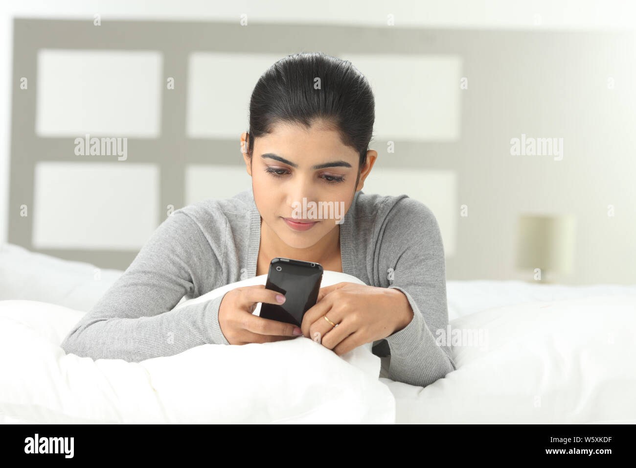 Messaging on bed hi-res stock photography and images - Alamy