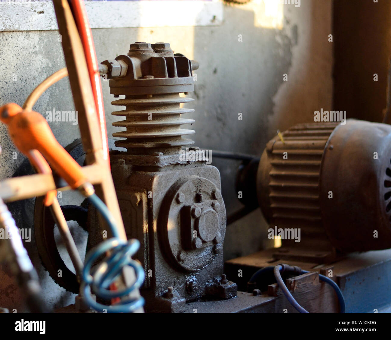 Air Compressor in a garage having compressor head in focus Stock Photo ...