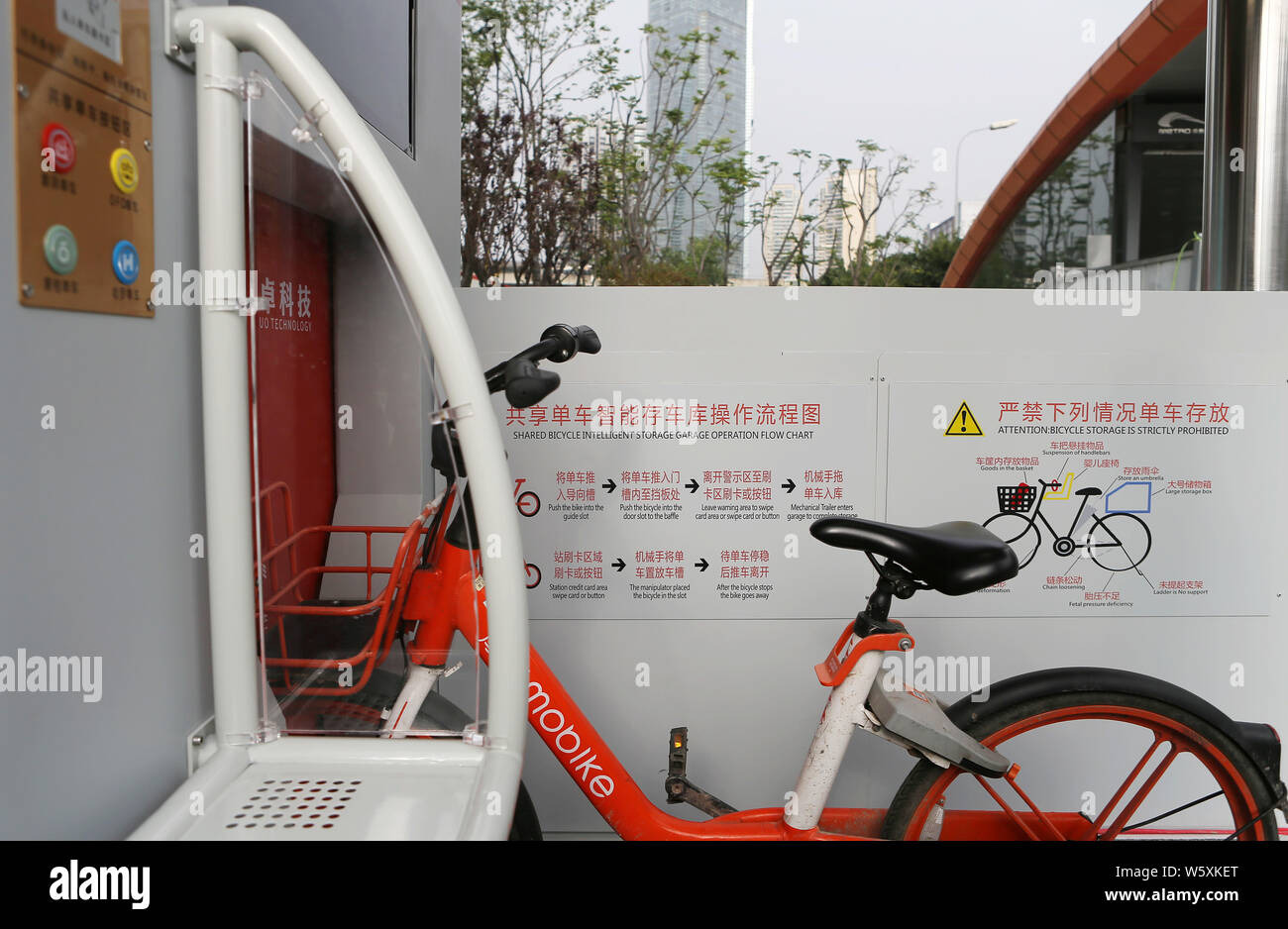 A bicycle of Chinese bike-sharing service mobike is lifted by a carrier and put into one of the ...